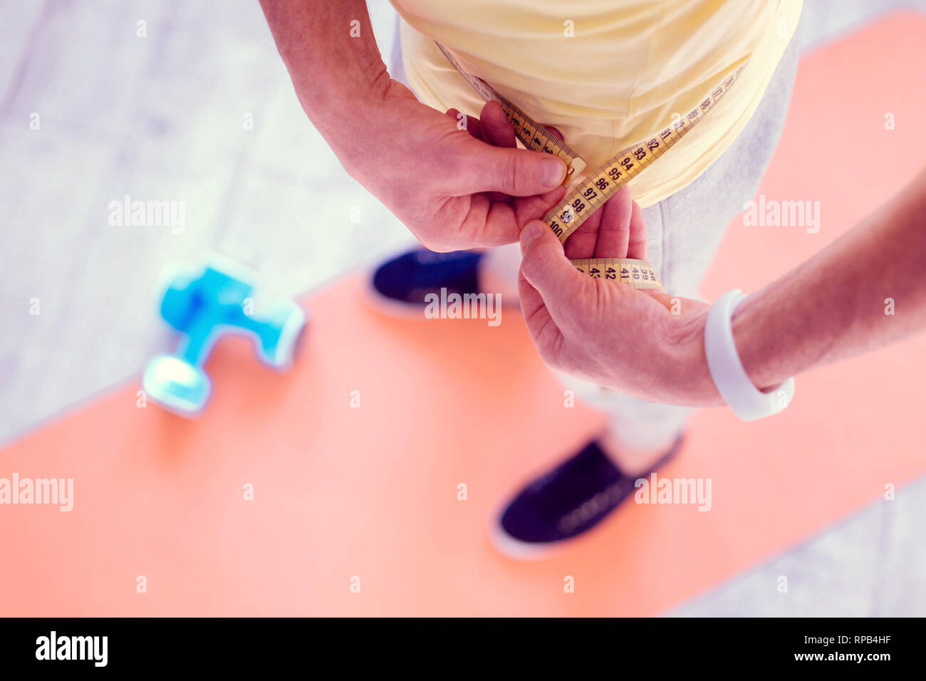 Man Wearing White Smart Watch On His Hand Measuring His Waistline Stock Photo Alamy man-wearing-white-smart-watch-on-his-hand-measuring-his-waistline-stock-photo-alamy