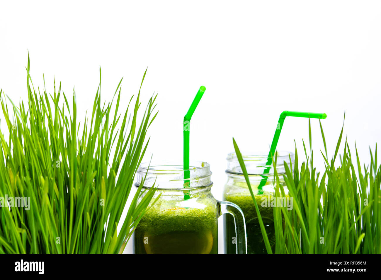 Wheat grass and smoothies isolated on white background Stock Photo - Alamy