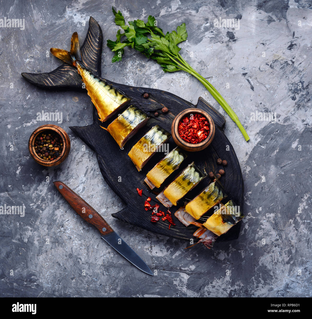 Smoked fish on kitchen board.Smoked mackerel.Smoked fish with spices ...