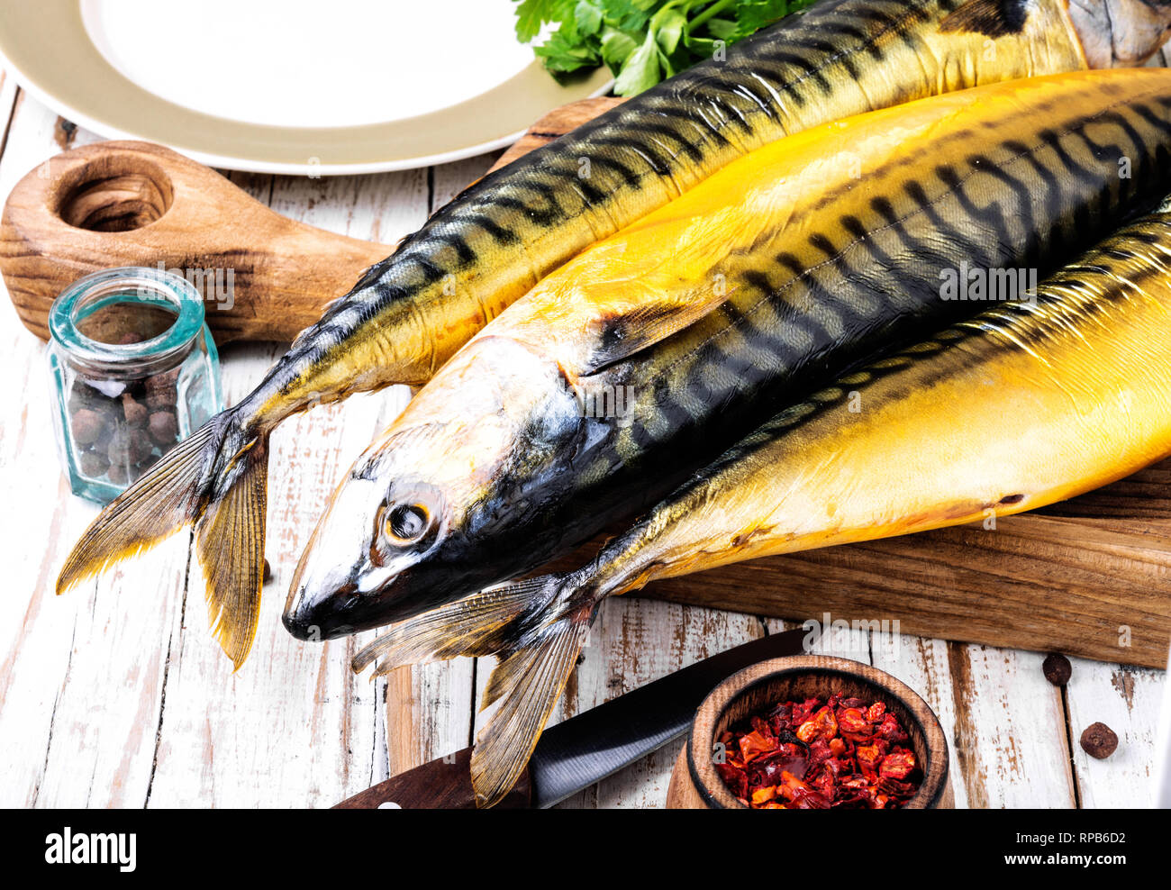 Smoked fish on kitchen board.Smoked mackerel.Smoked fish with spices ...