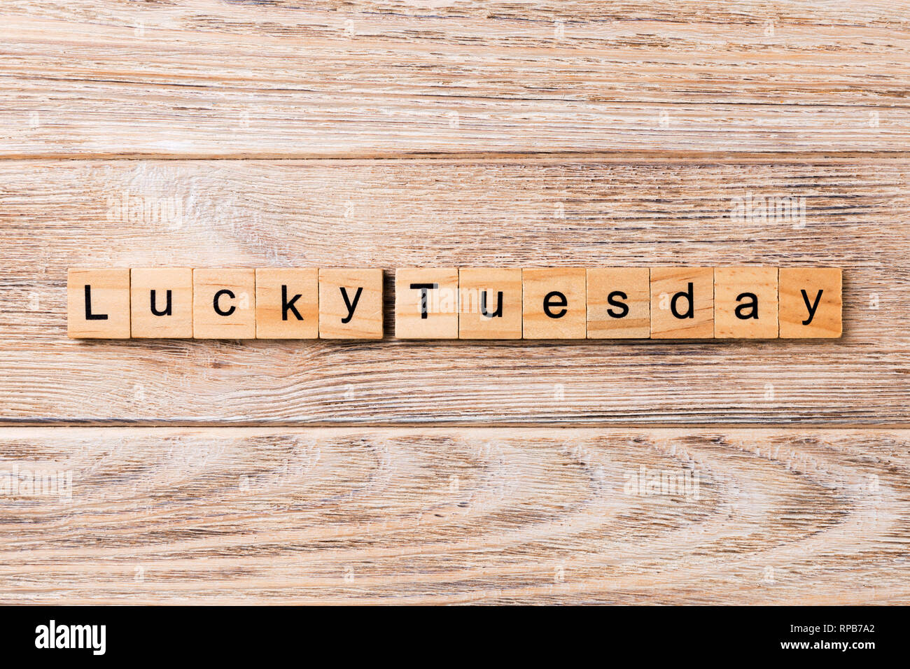 Lucky Tuesday word written on wood block. Lucky Tuesday text on wooden ...
