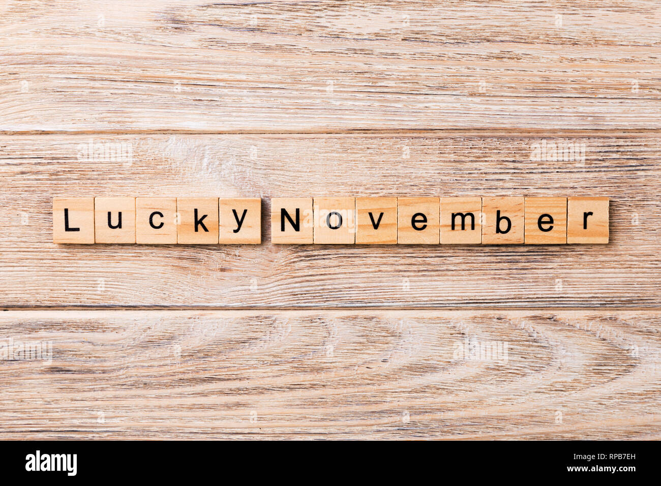 lucky november word written on wood block. lucky november text on table ...
