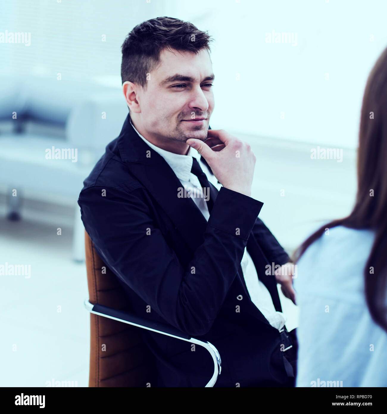 successful employee sitting behind a Desk in the office Stock Photo - Alamy