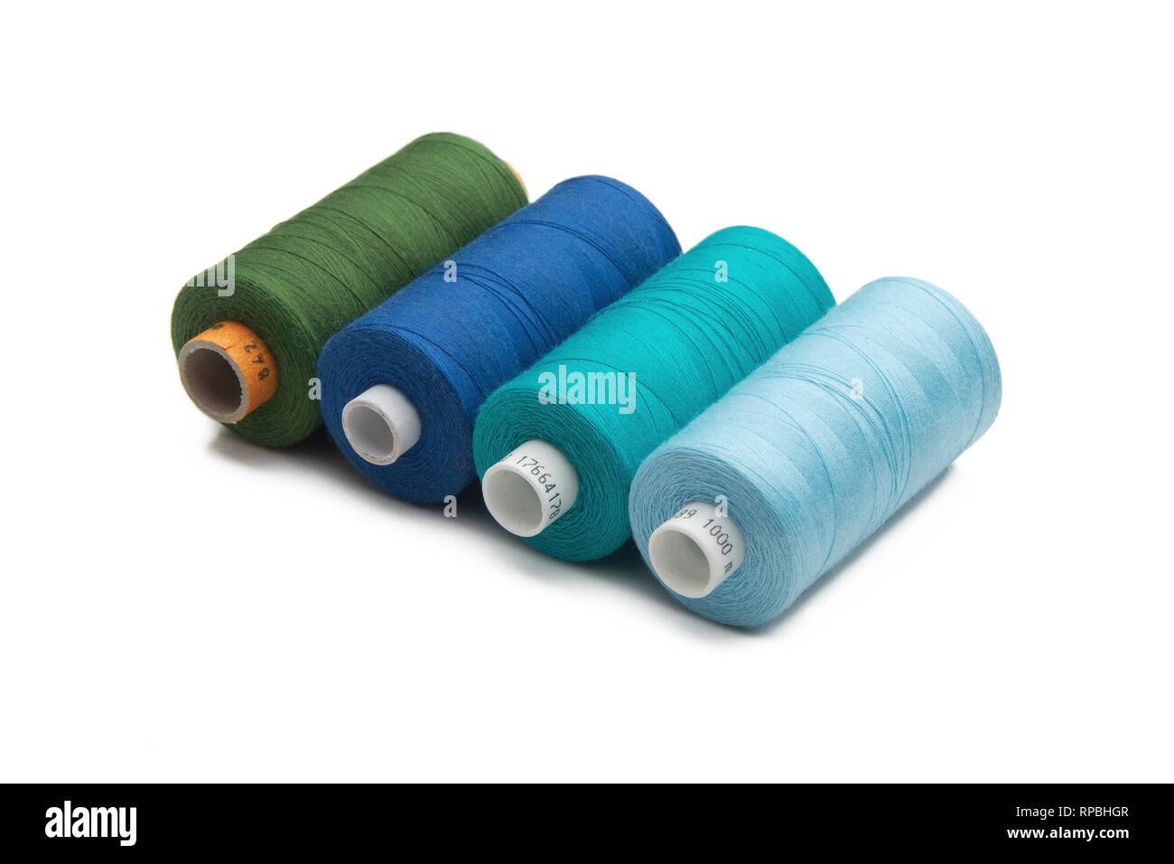 Rainbow colored sewing thread lined in a row Stock Photo - Alamy