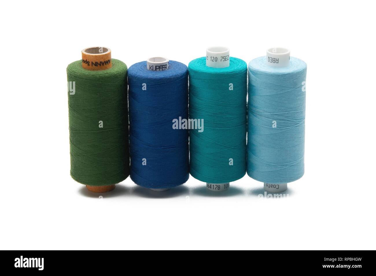 Rainbow colored sewing thread lined in a row Stock Photo - Alamy