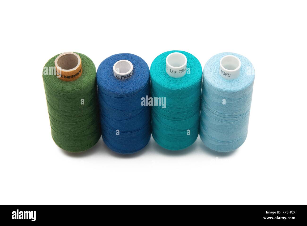 Rainbow colored sewing thread lined in a row Stock Photo - Alamy
