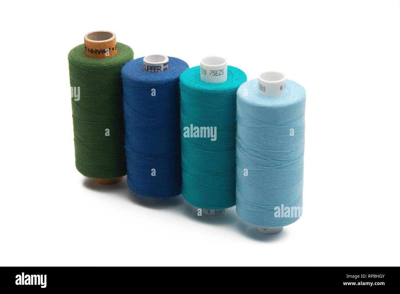 Rainbow colored sewing thread lined in a row Stock Photo - Alamy