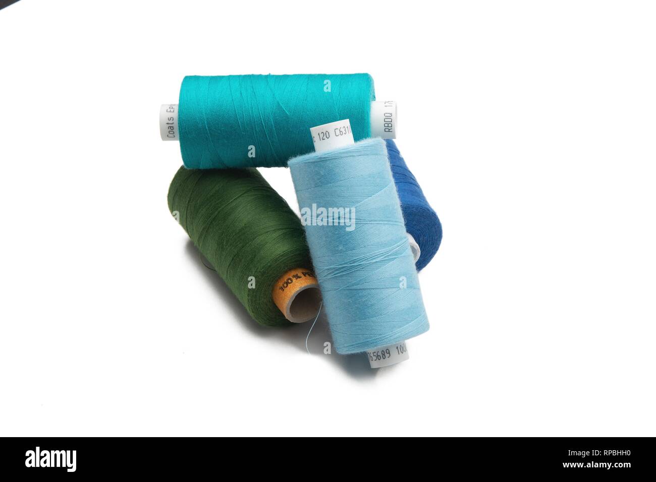 Rainbow colored sewing thread lined in a row Stock Photo - Alamy