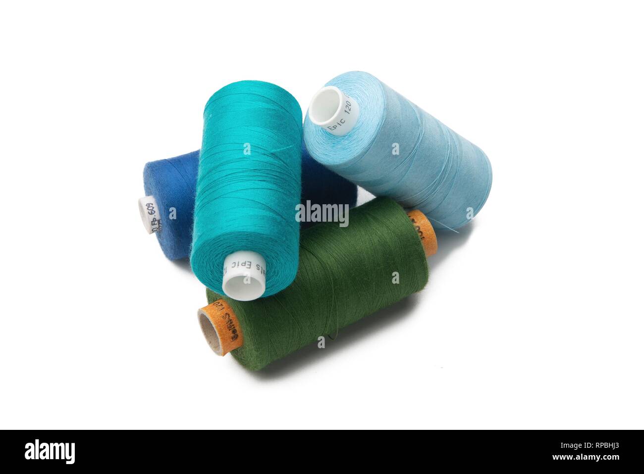 Rainbow colored sewing thread lined in a row Stock Photo - Alamy