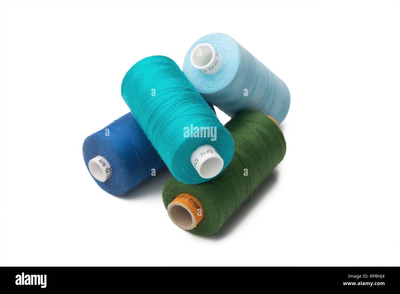 Rainbow colored sewing thread lined in a row Stock Photo - Alamy