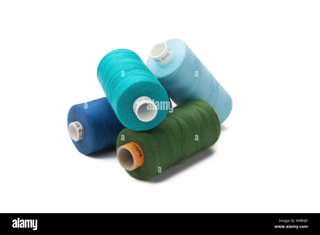 Rainbow colored sewing thread lined in a row Stock Photo - Alamy