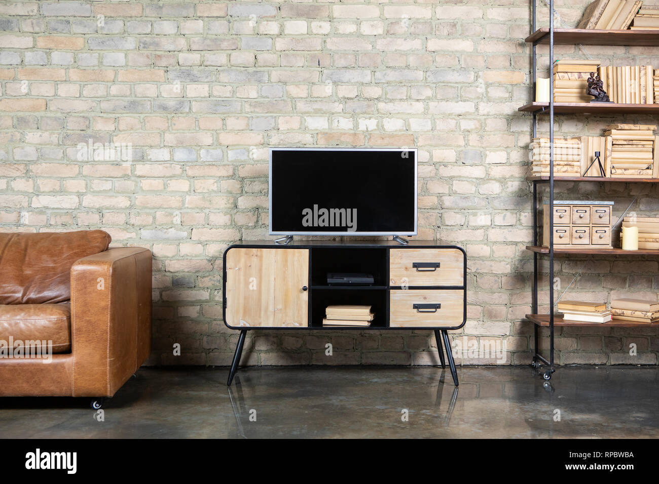 TV in the interior in loft style on the bedside table with decorative ...