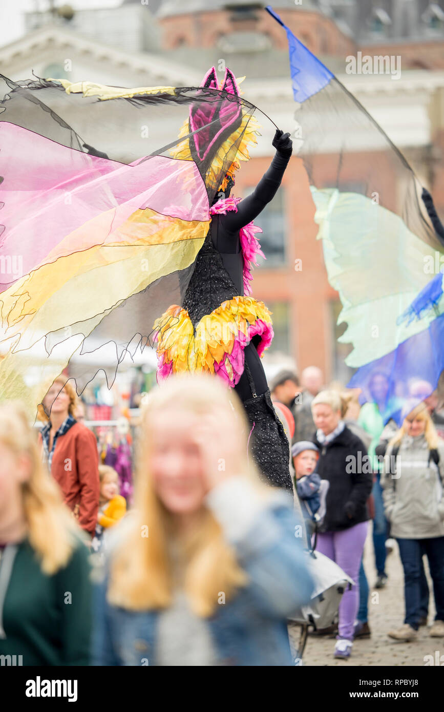 Colourful performance on stilts in the middle on the market square of ...