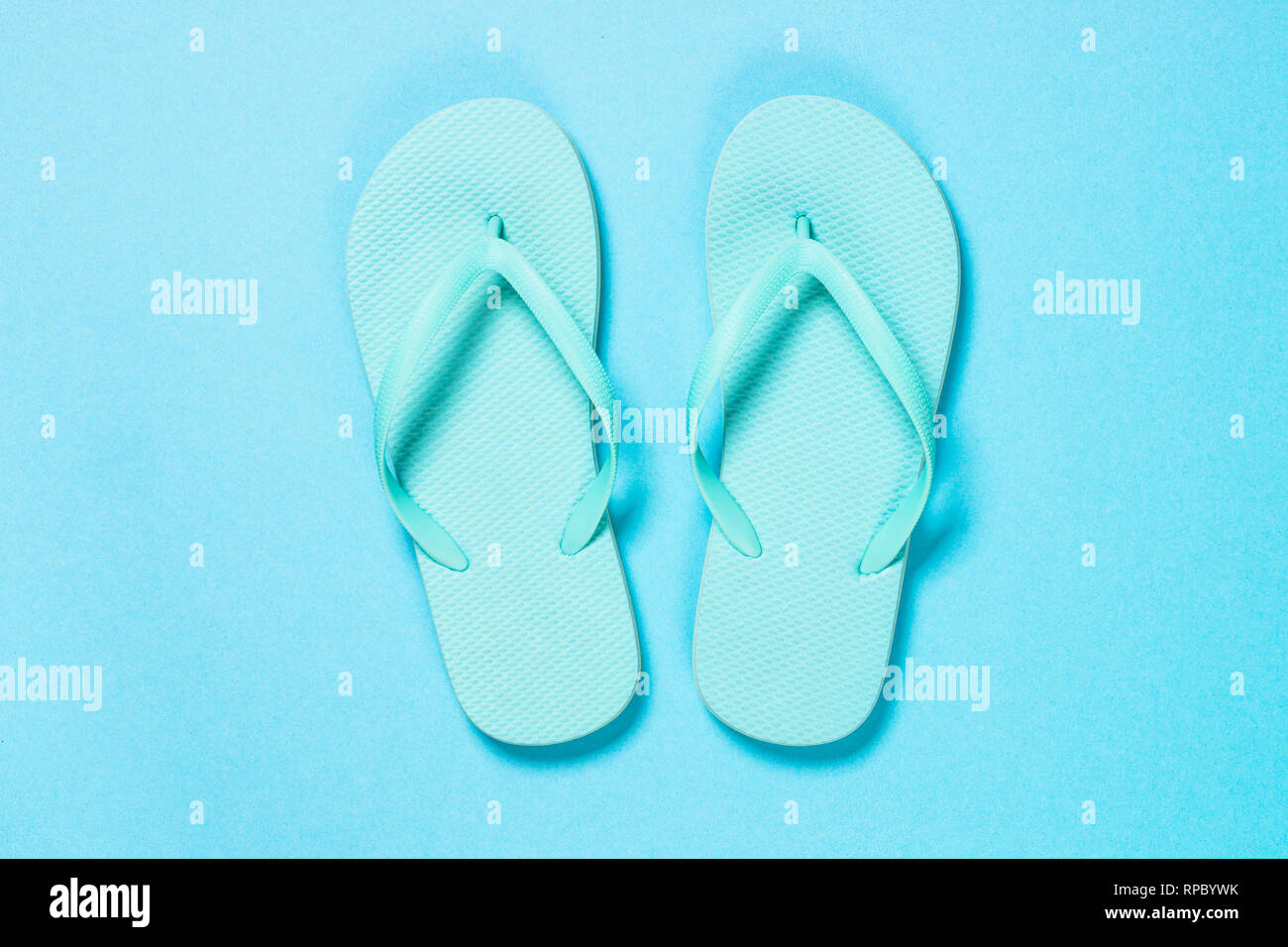 Blue flip flops on blue background Stock Photo - Alamy