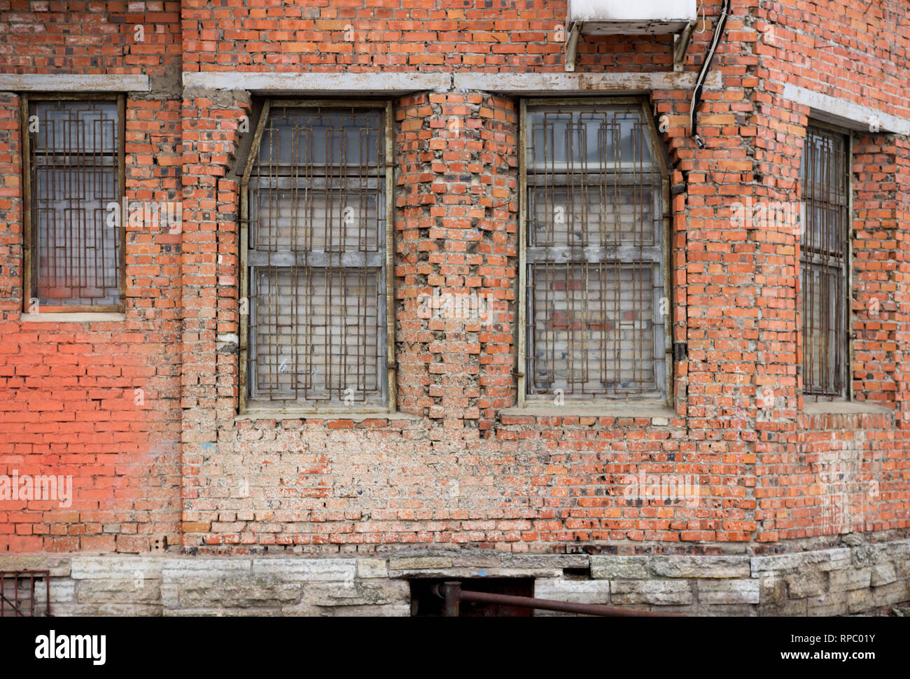 red brick residential building with rectangular windows protected by a ...