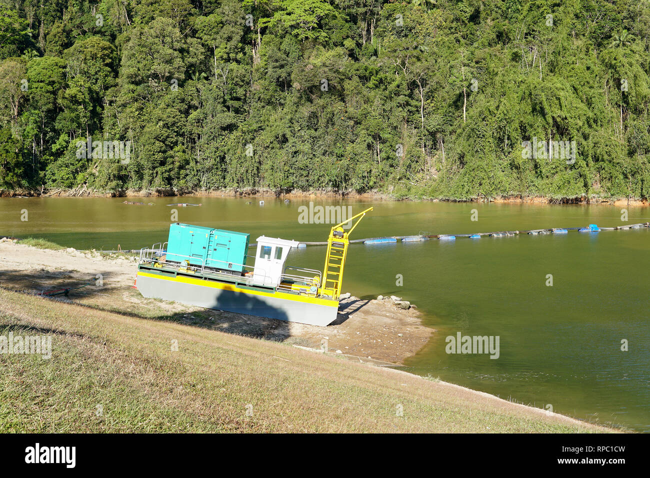Sand dredging boat ,pump and excavator removing sand from the river bed ...