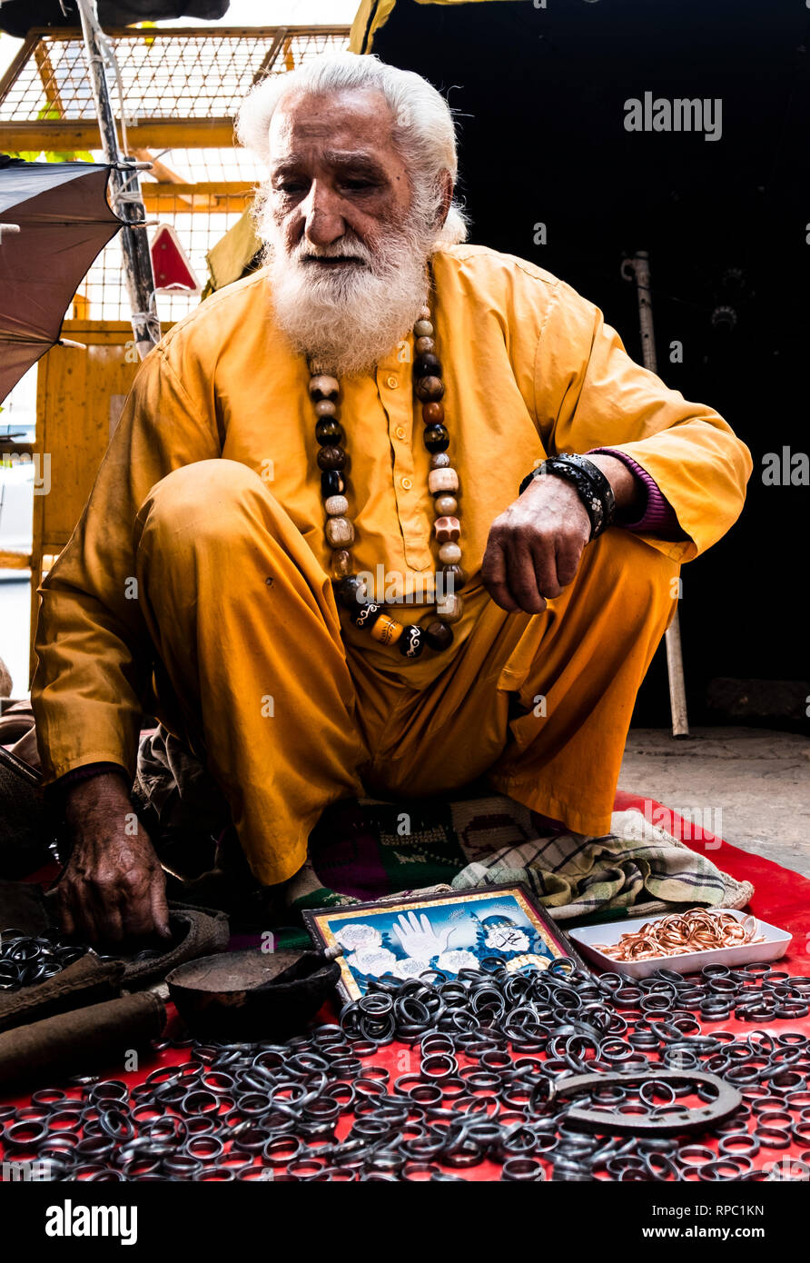 An Islamic Shaman selling rings that supposedly are good luck charms ...