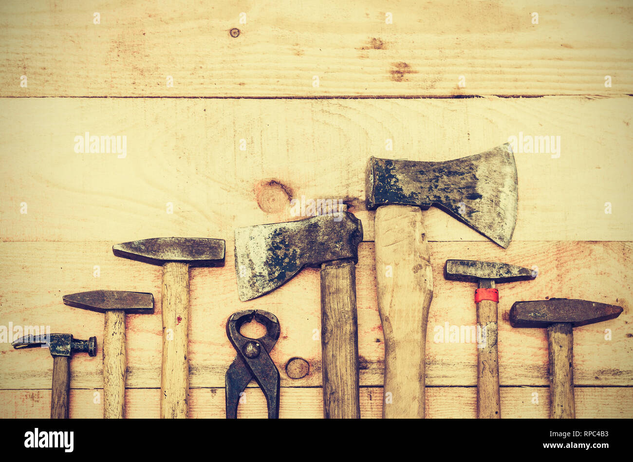 Set of old vintage hand construction tools on a wooden background, well ...