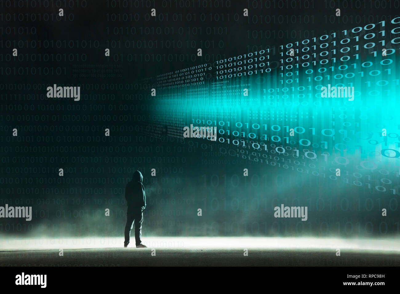 A cyber crime concept of a lone hooded figure looking at glowing ...