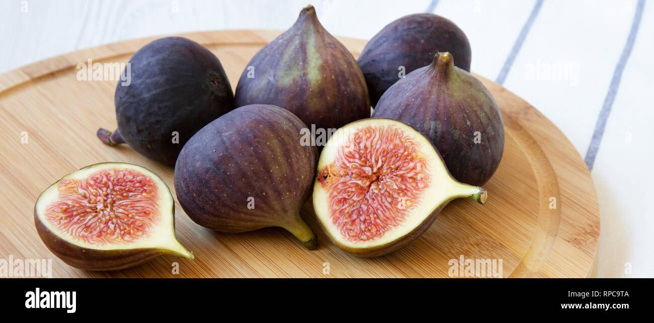 Fresh figs on round bamboo board, side view. Close-up Stock Photo - Alamy