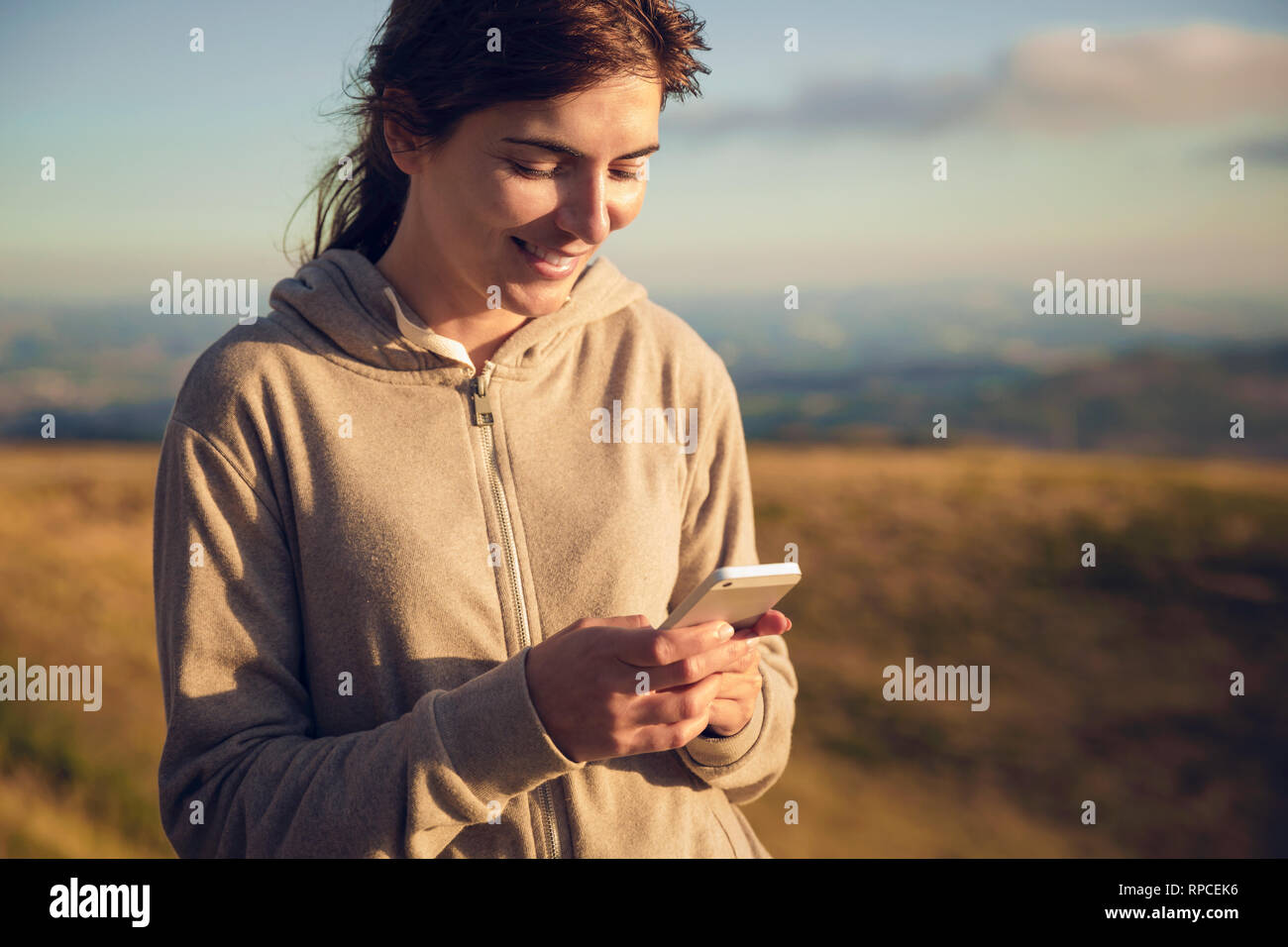 Woman sending a text message Stock Photo - Alamy