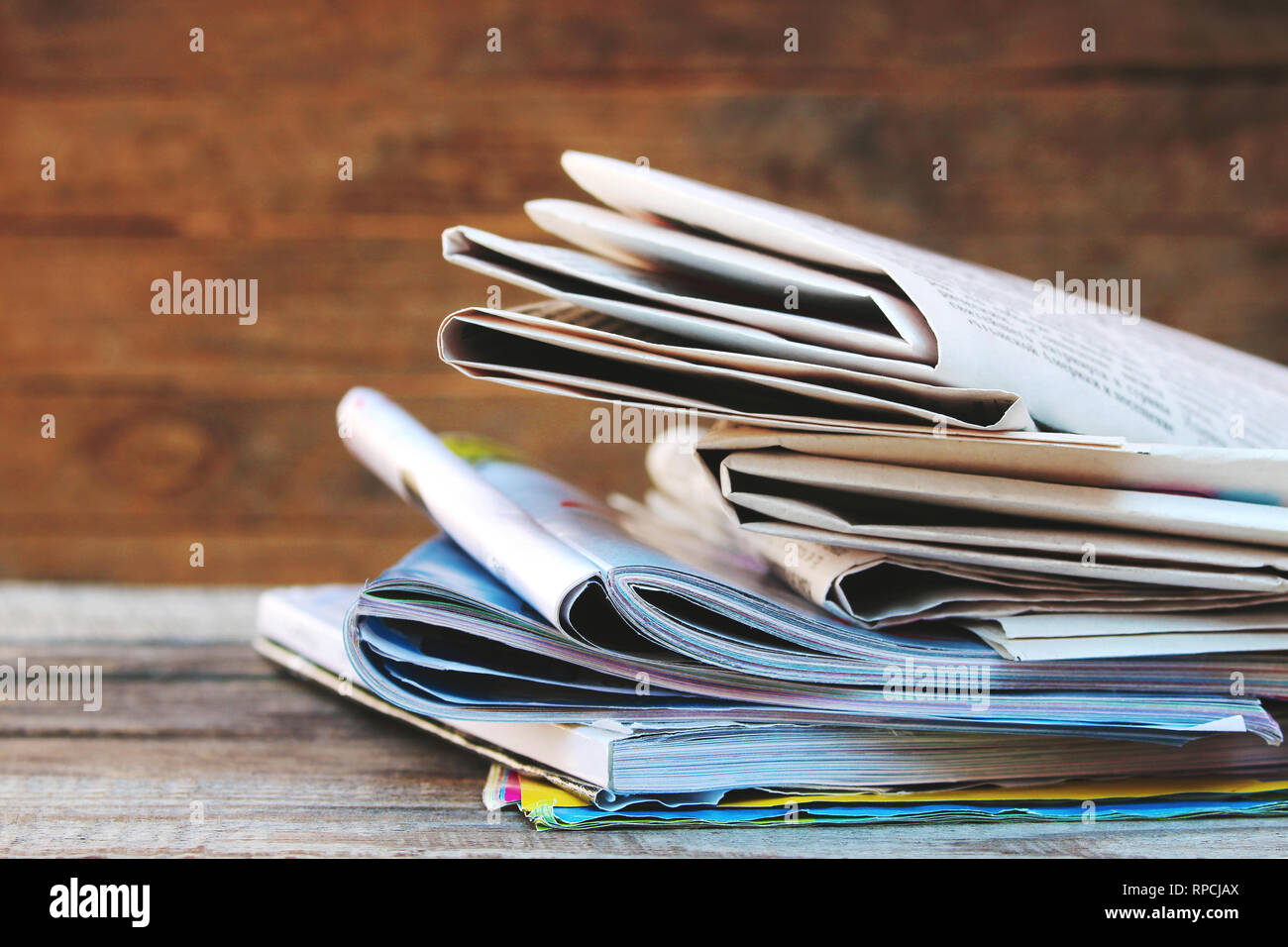 Newspapers and magazines on old wood background. Toned image Stock ...