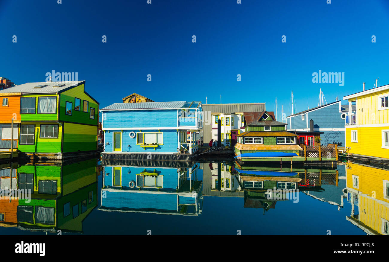 The colorful village of float homes on a bright sunny day, blue sky ...