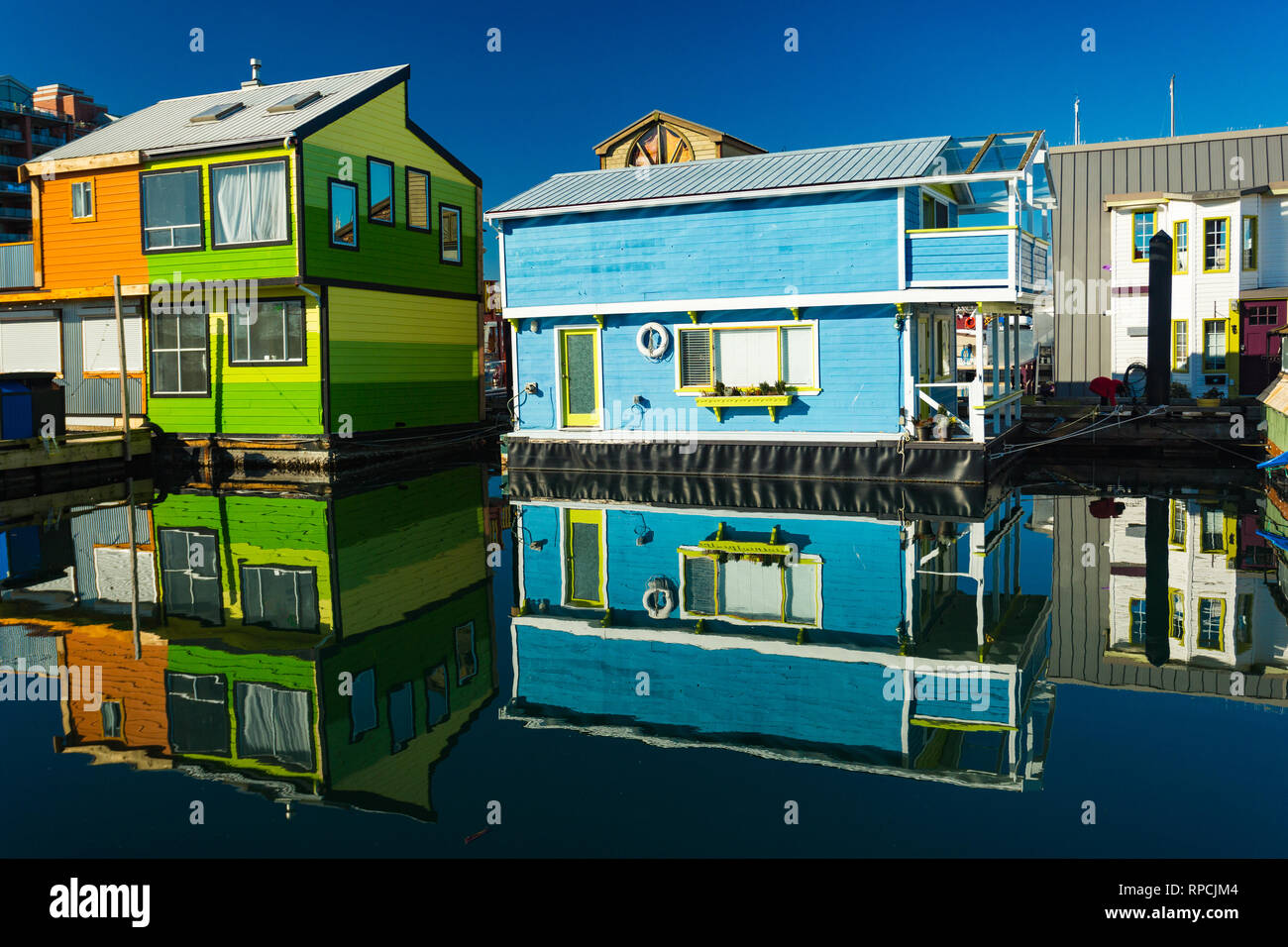 The colorful village of float homes on a bright sunny day, blue sky ...