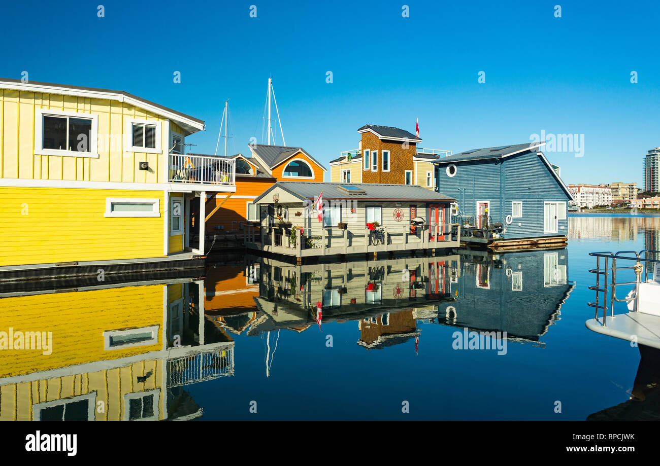 The colorful village of float homes on a bright sunny day, blue sky ...
