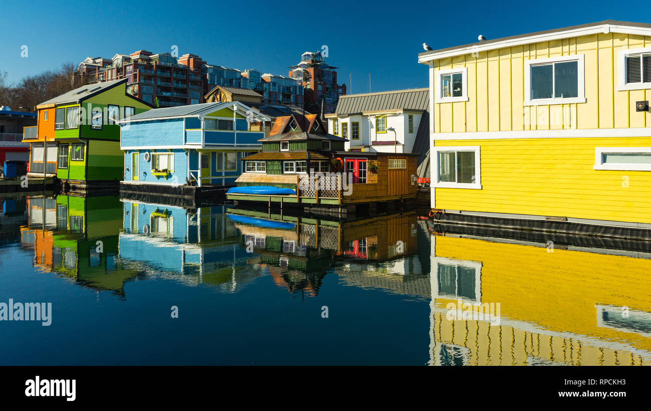 The colorful village of float homes on a bright sunny day, blue sky ...