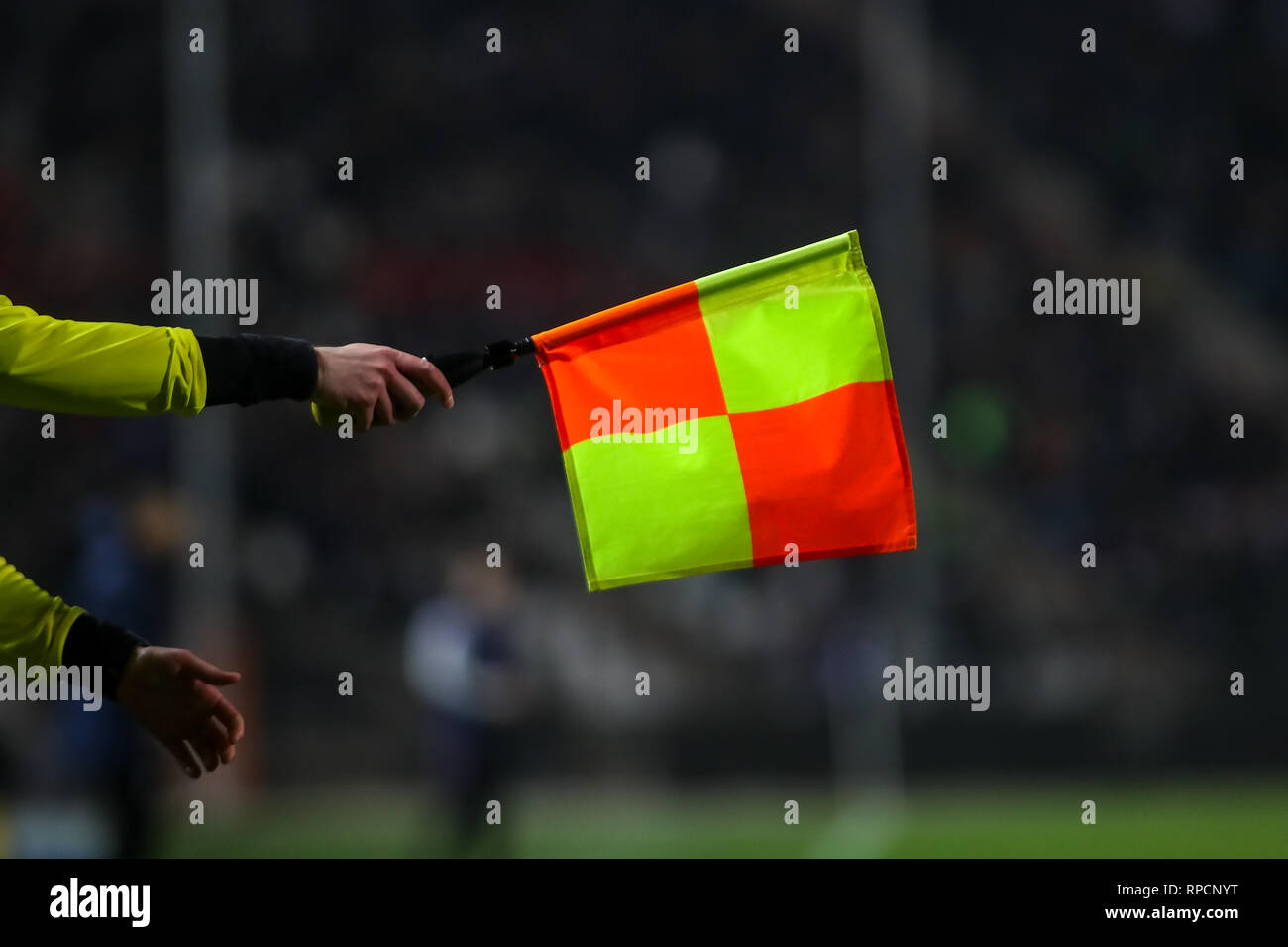 The assistant referee holds out his offside flag hi-res stock ...