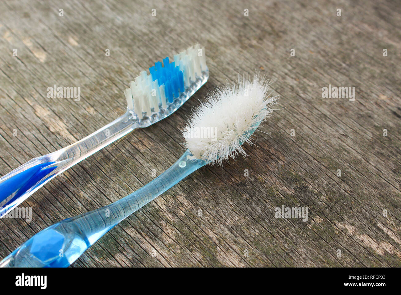 Old and new toothbrushes on old wooden background Stock Photo - Alamy