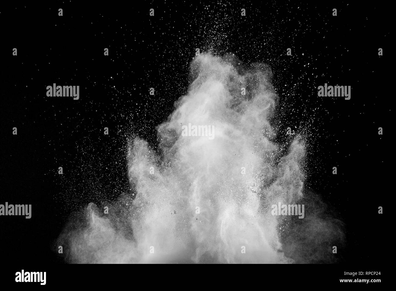 Bizarre forms of white powder explosion cloud against black background ...