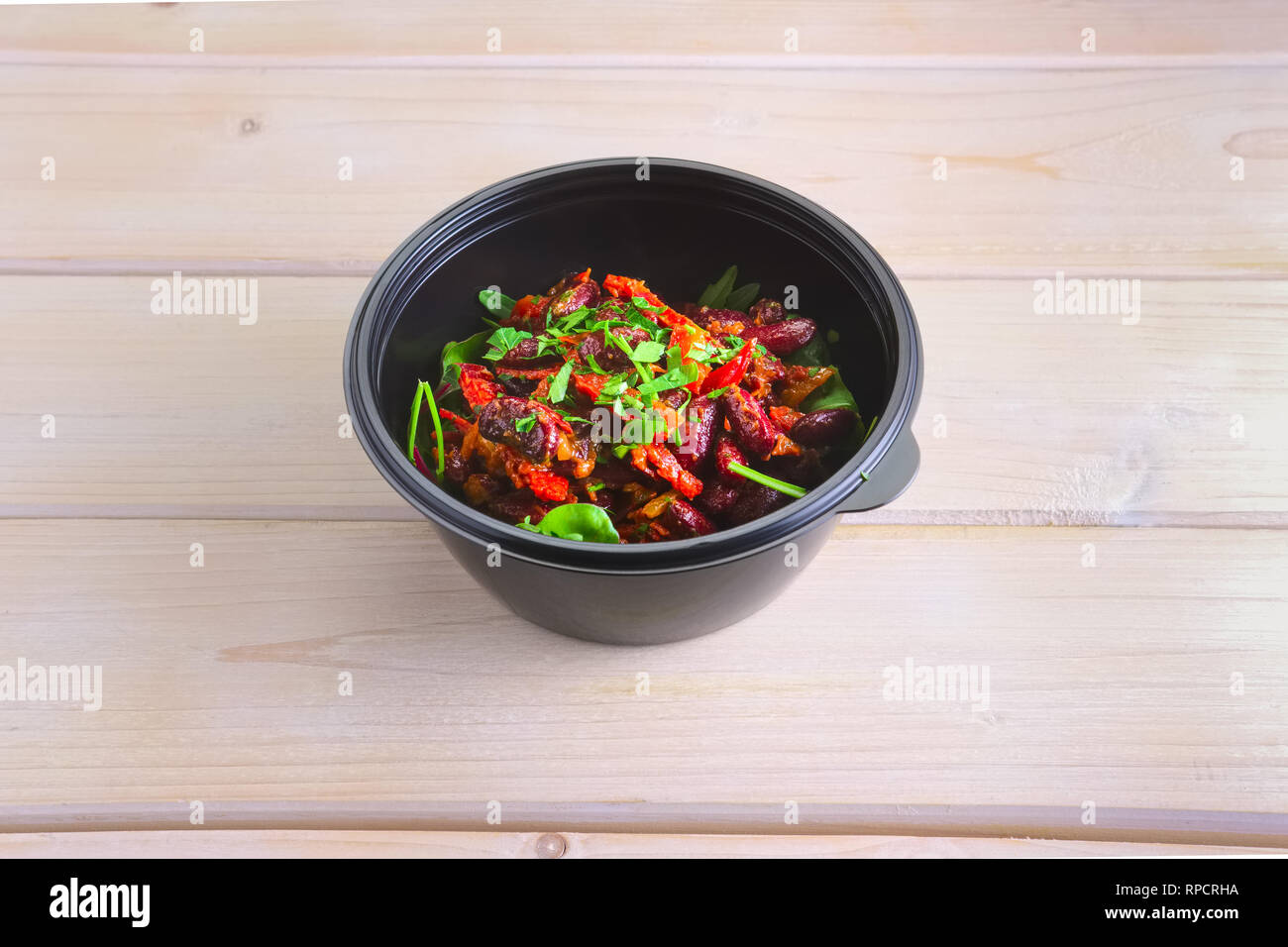Salad with red beans, paprika and sun dried tomatoes in take away ...