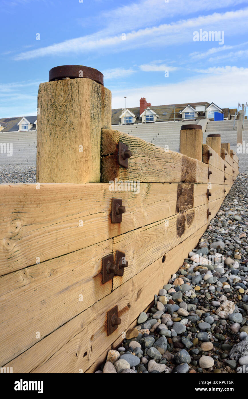 New wooden groyne with rusty steel bolts, green algae beginning to grow ...