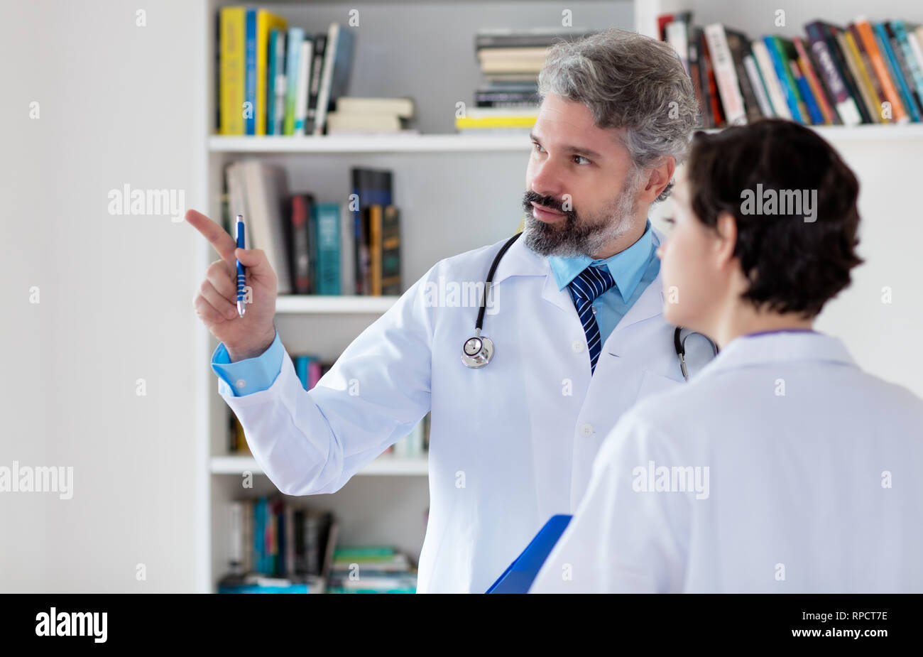 General practitioner talking with medical student about therapy of ...