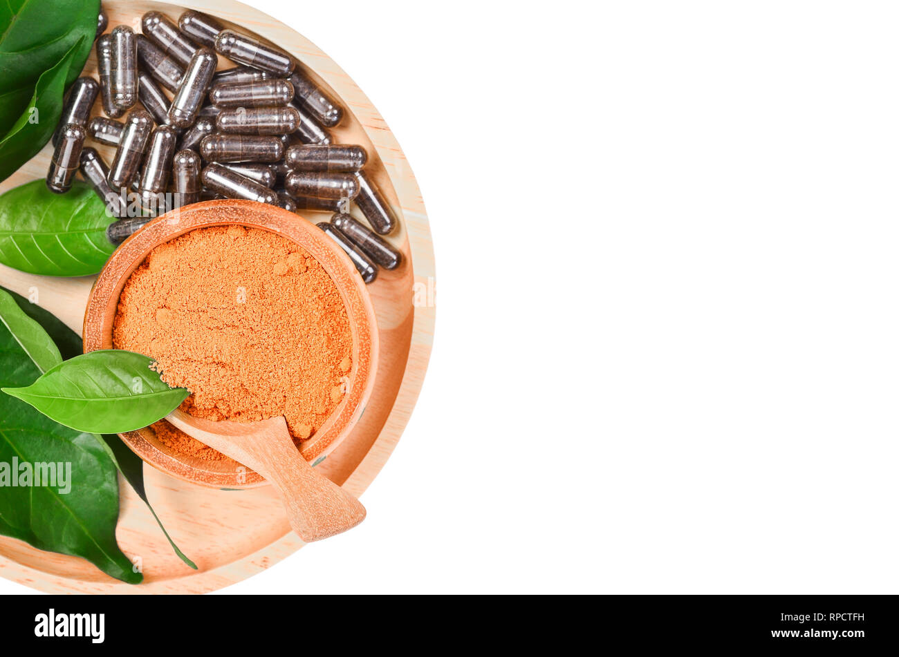 Natural medicine capsule pill with black herb, and wooden mortar on ...