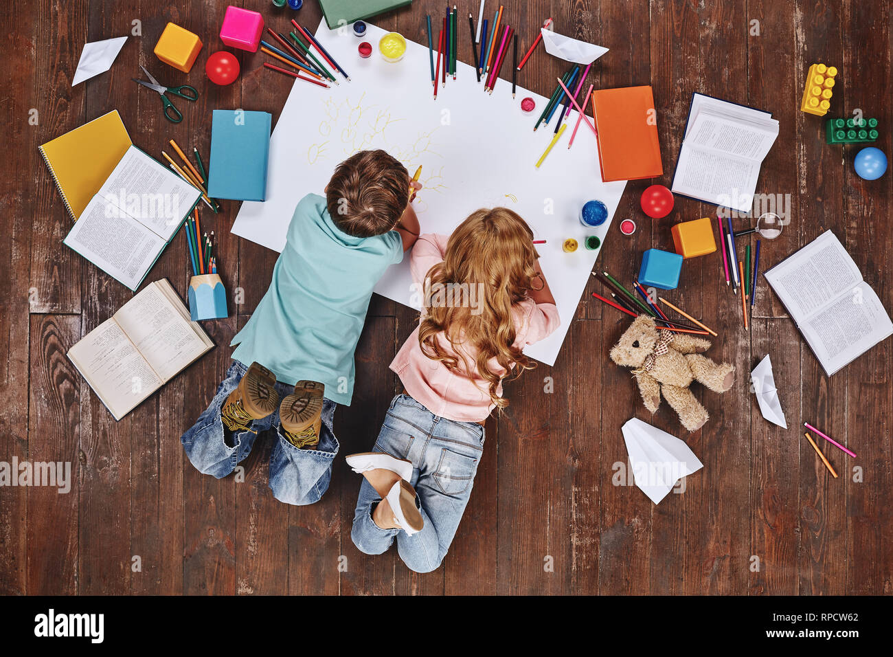 Happy children. Top view creative photo of little boy and girl on ...