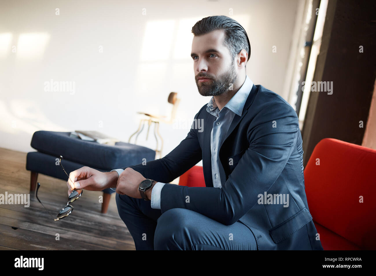 Feeling confident. Attractive and stylish businessman in a fashion suit ...
