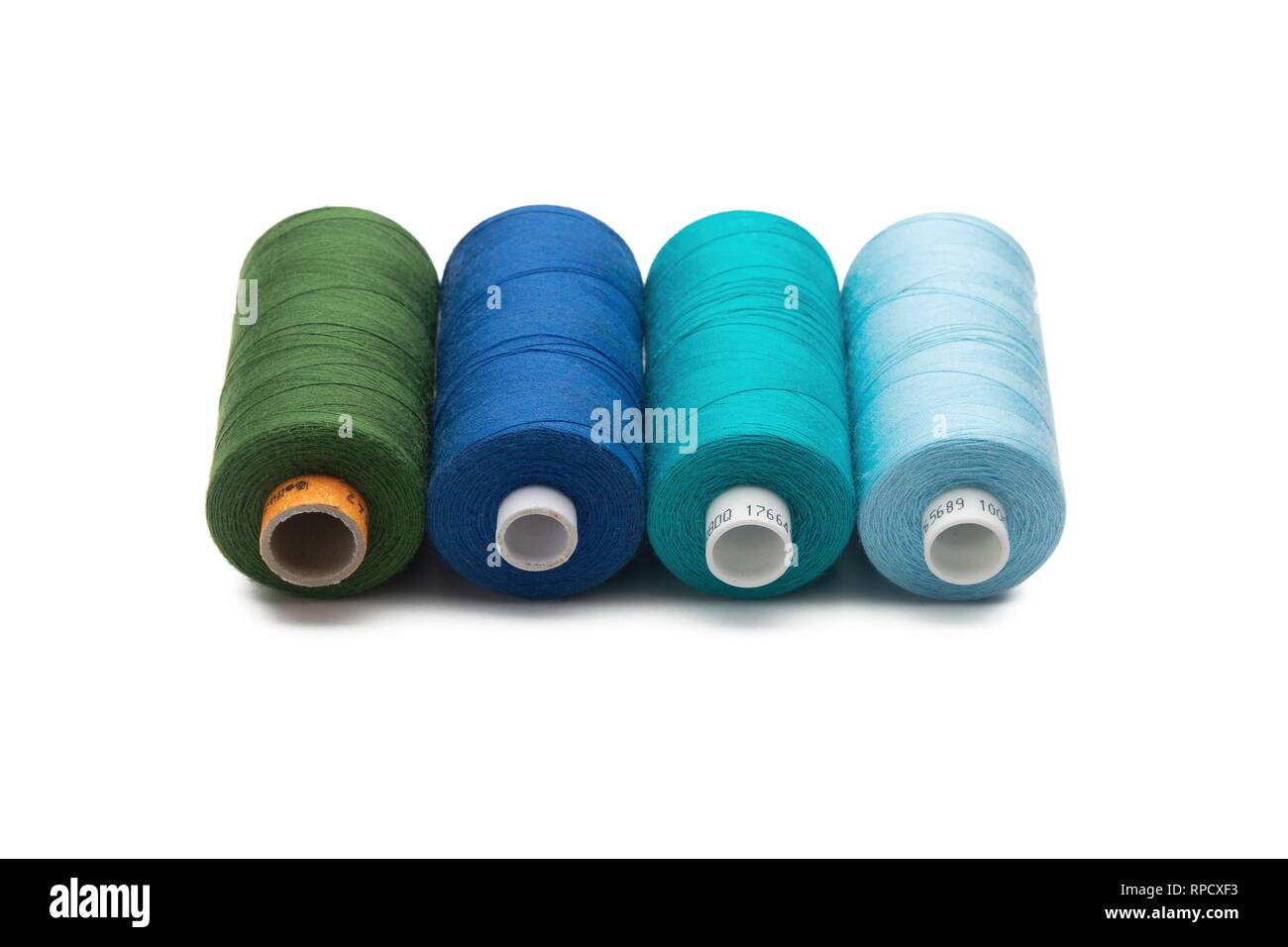 Rainbow colored sewing thread lined in a row Stock Photo - Alamy