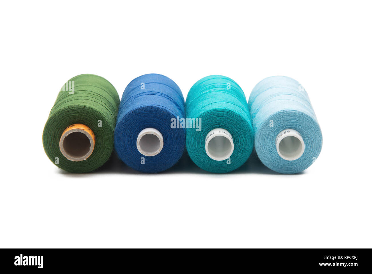 Rainbow colored sewing thread lined in a row Stock Photo - Alamy