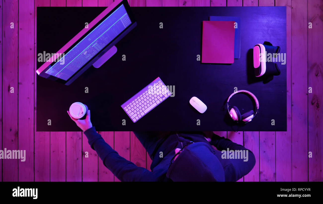 Top view.Male hooded gamer watching a game on computer. Professional ...