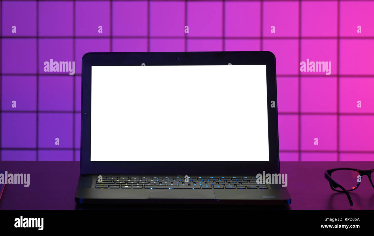 Dolly out. Gamer's laptop on a table with view to the screen. White ...