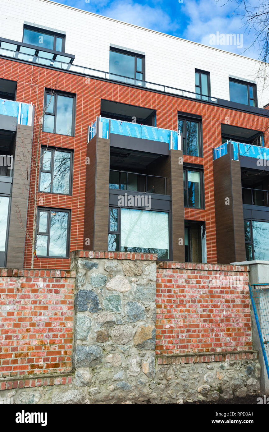 Low angle view on modern residential brick apartment building exterior ...