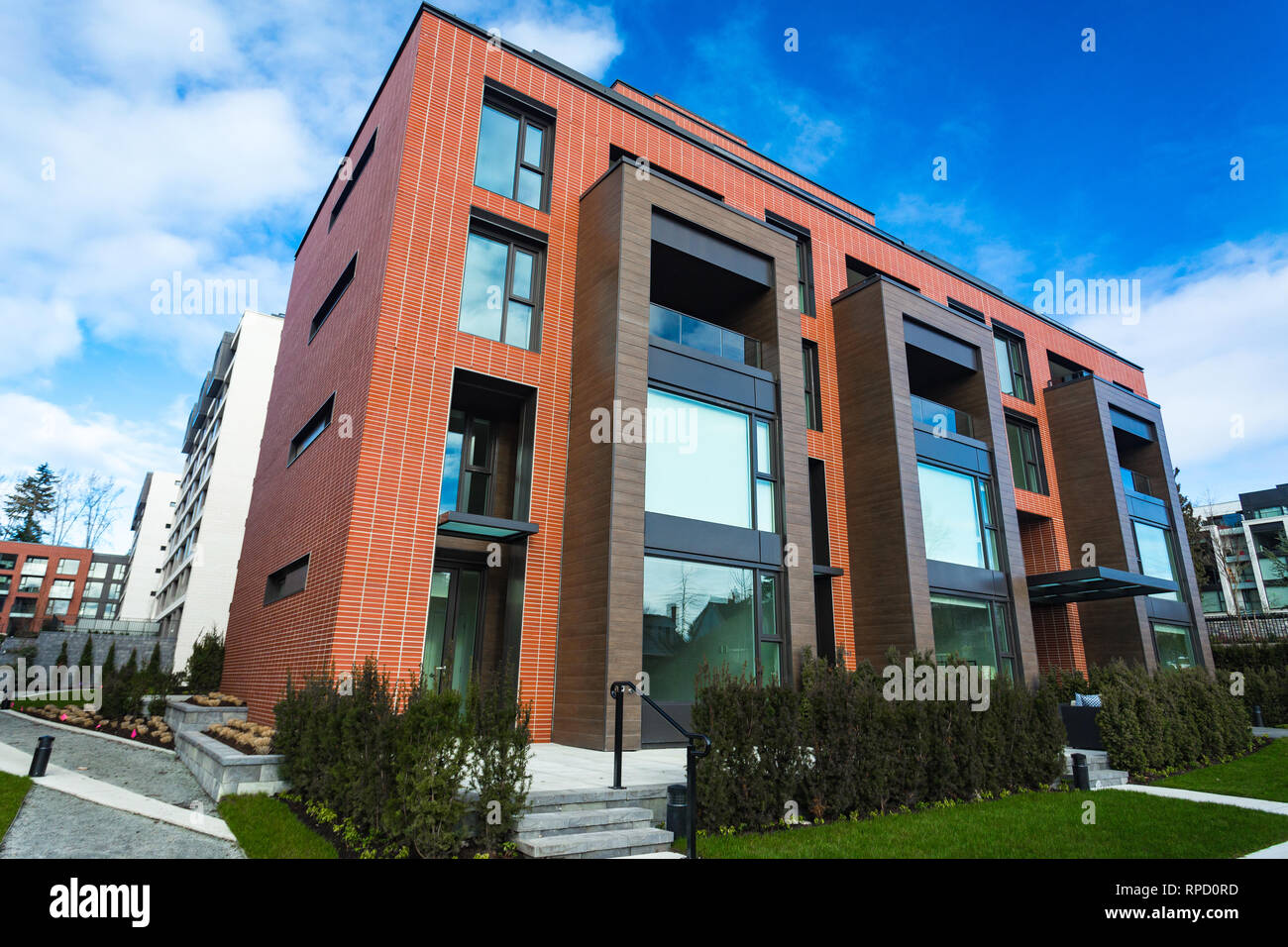 Modern Red Brick Apartment Complex with solid rock fence wall. Home ...
