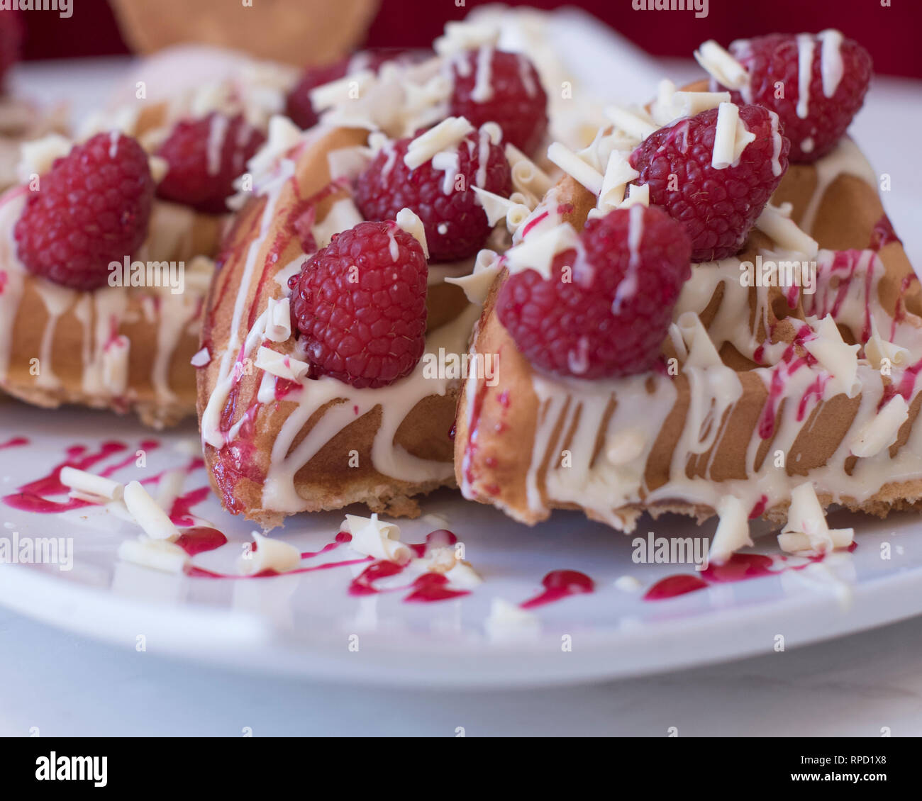 delicious desserts raspberry waffles with white chocolate drizzle Stock ...