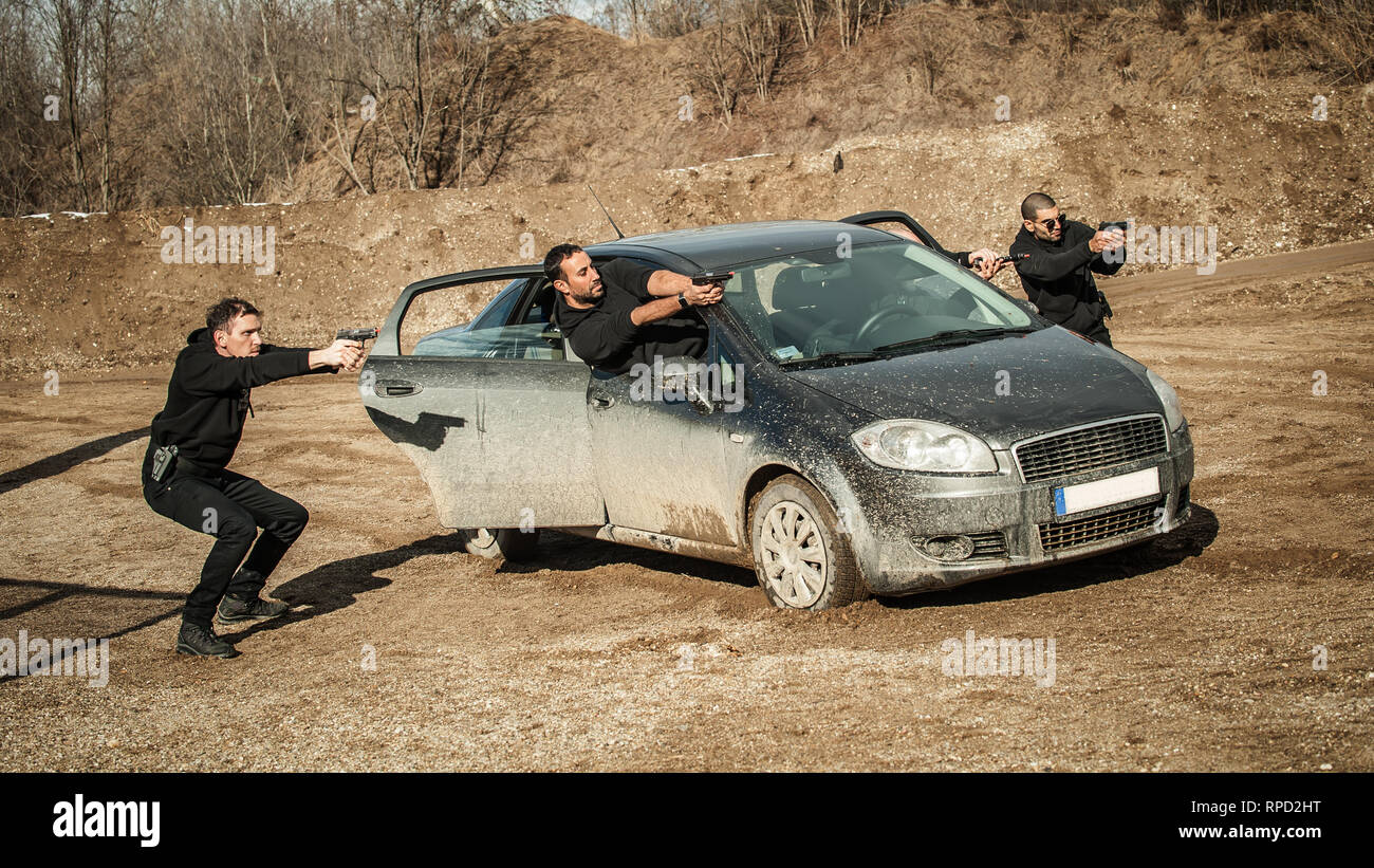 Police agent and bodyguard training action gun shooting from car ...