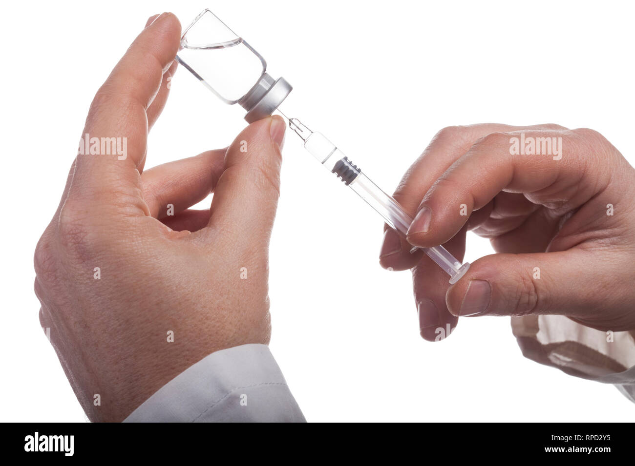 A syringe and a bottle with an injection solution on white background ...
