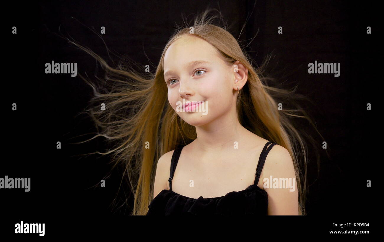 Wind blowing on girls face. Close up, cute adorable little model ...