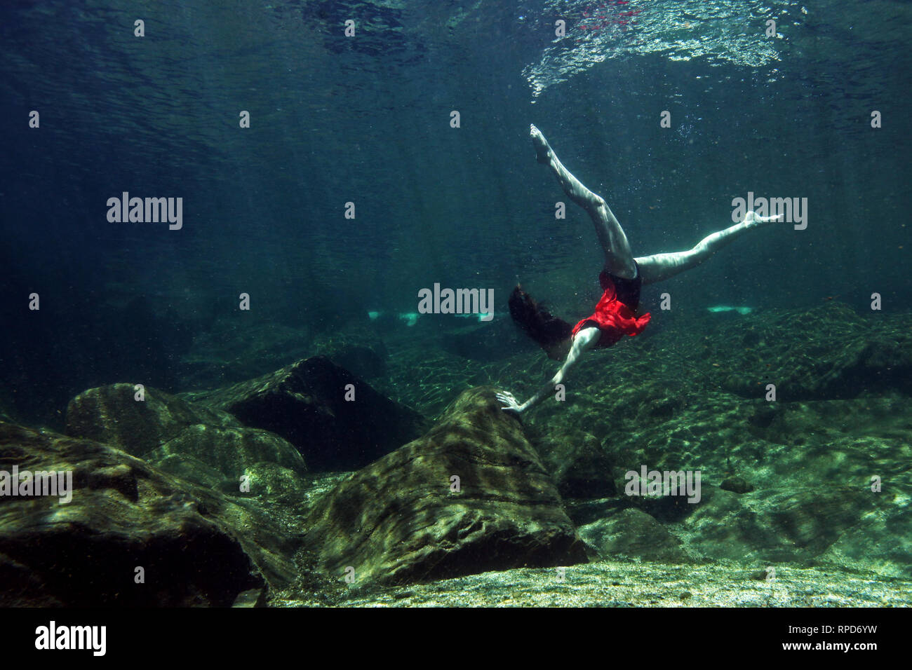 A female dancer dancing underwater near Verdelhos, Serra da Estrela ...